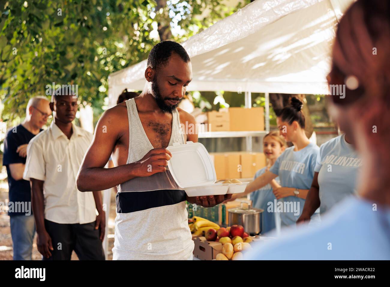 Image of african american homeless guy holding his free food provided ...