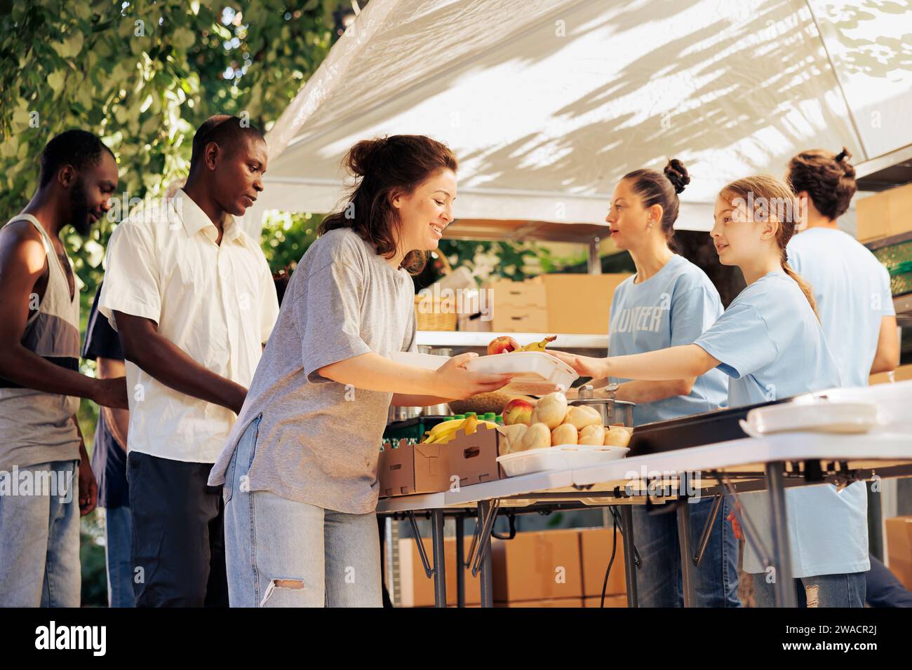 Charity workers helping homeless, refugees and the needy by ...