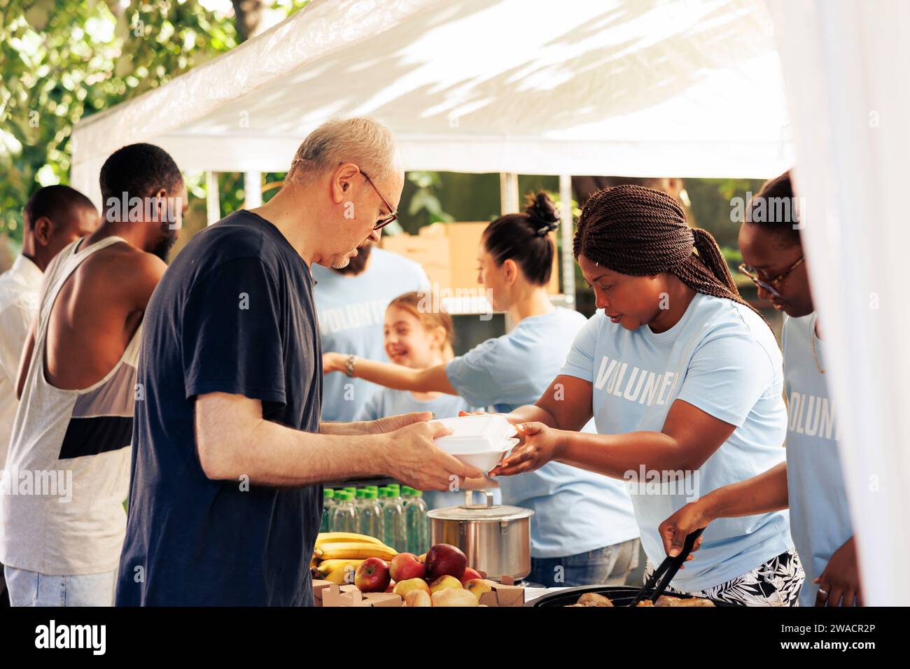 Young volunteers at local center giving complimentary nourishment to ...