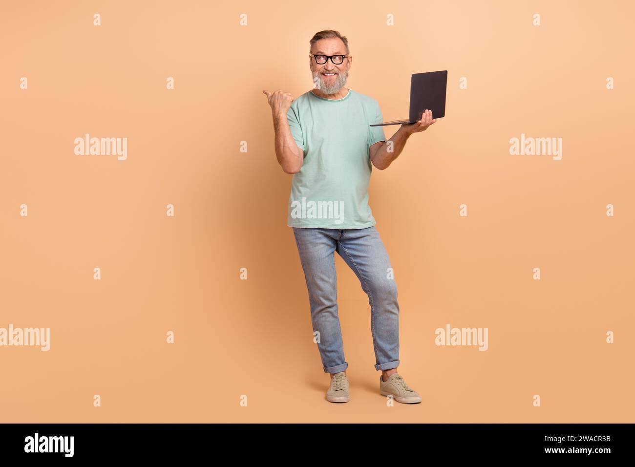 Full size portrait of handsome man use laptop look indicate finger ...