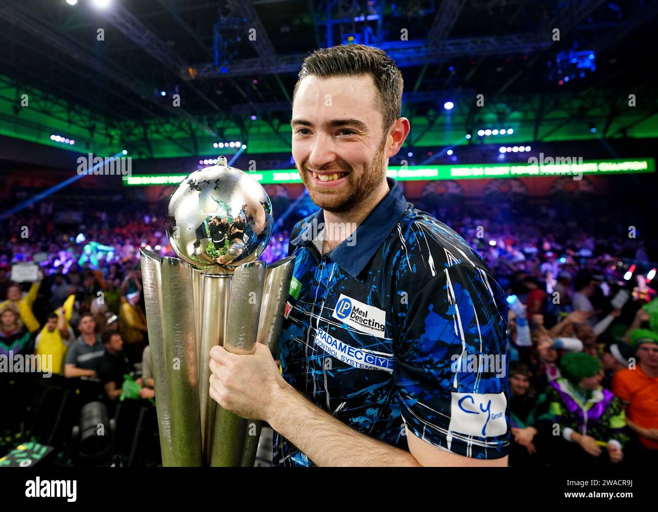 Luke Humphries celebrates with his trophy after beating Luke Littler in ...