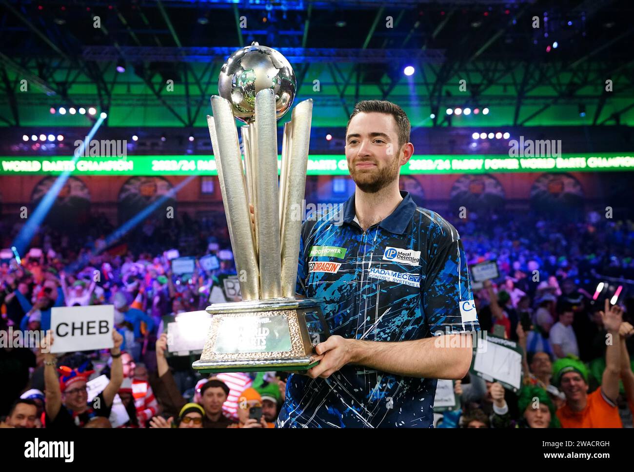 Luke Humphries celebrates with his trophy after beating Luke Littler in ...