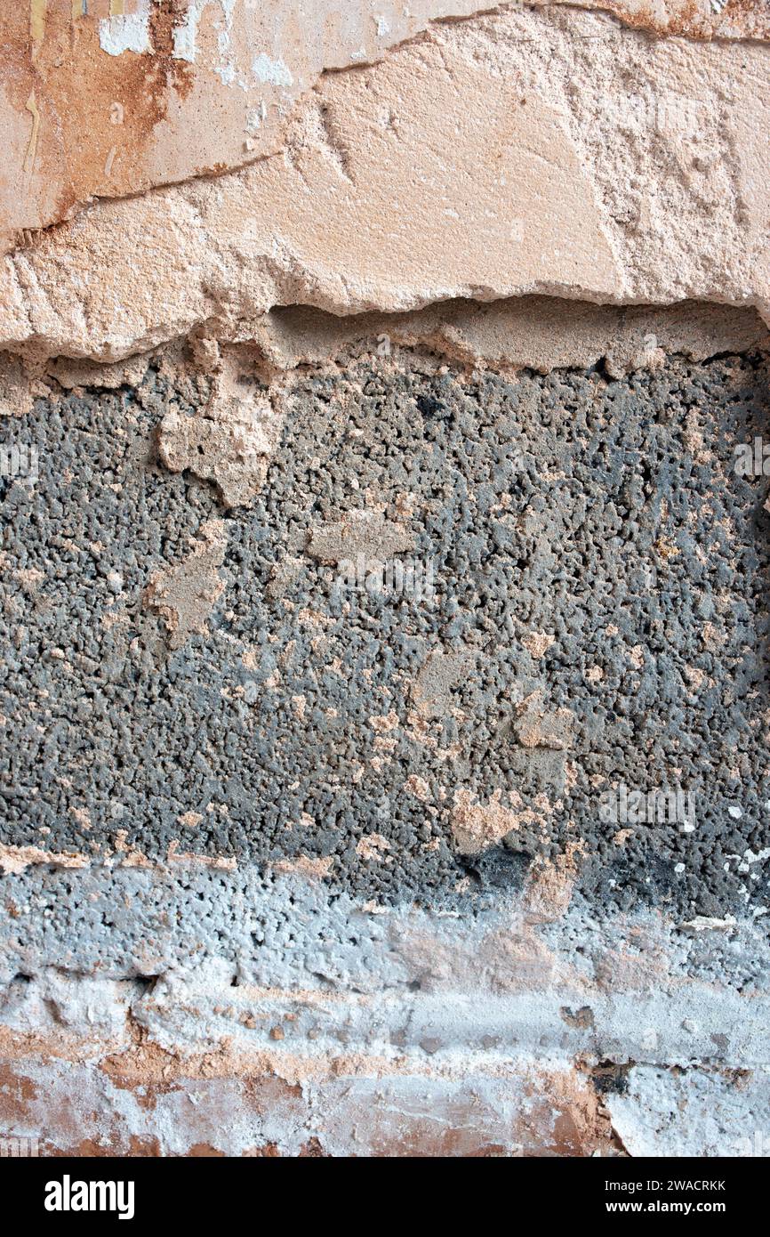 Damaged damp plaster exposing brick in a bathroom. Home improvement ...