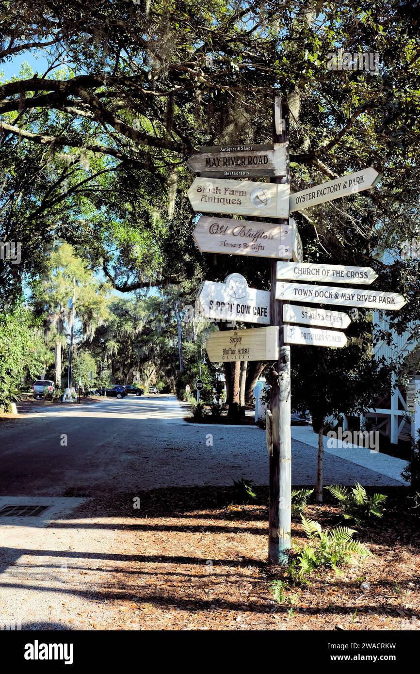 Wooden crossroads sign in Bluffton, South Carolina pointing to various ...