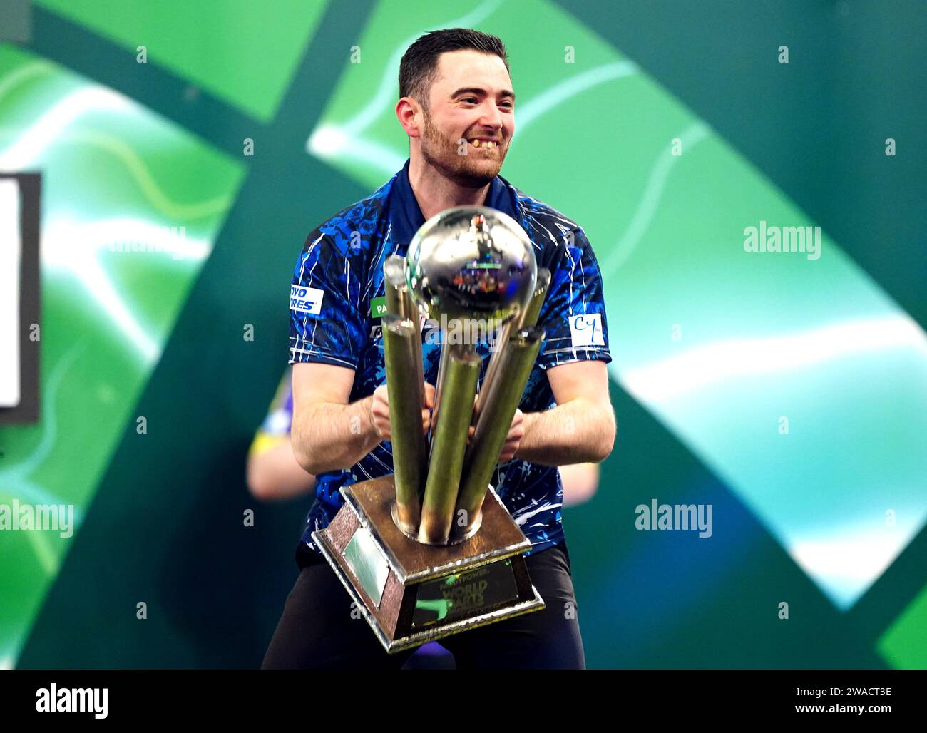 Luke Humphries celebrates with the trophy after winning the final of ...
