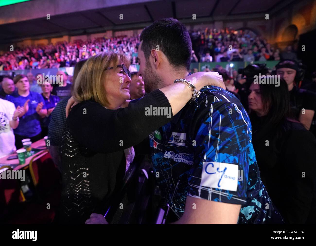 Luke Humphries celebrates with his family after winning the final of ...