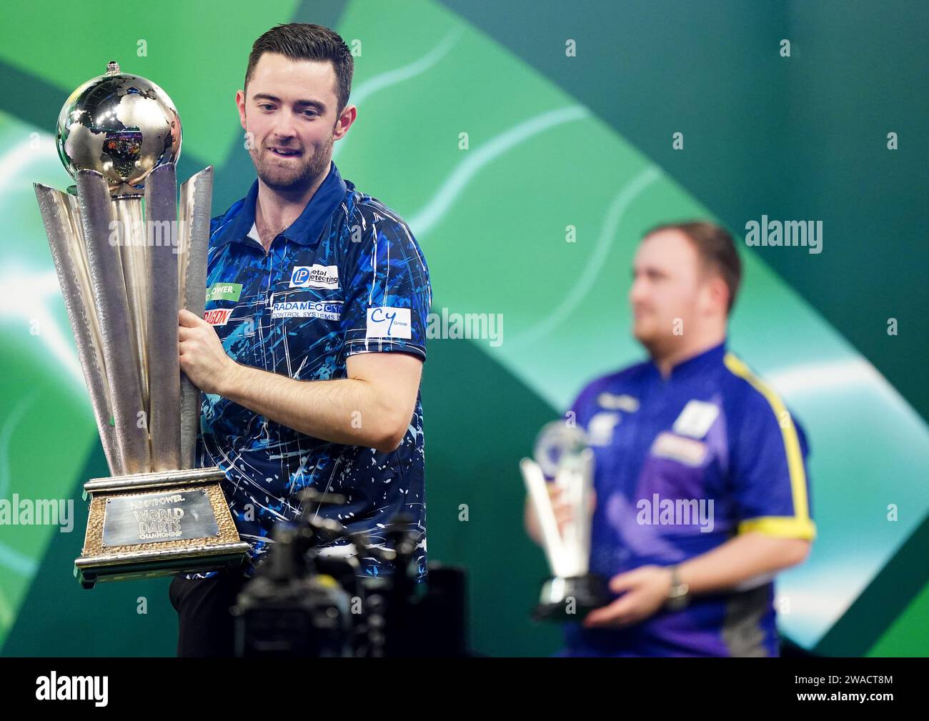 Luke Humphries celebrates with the trophy after winning the final of ...