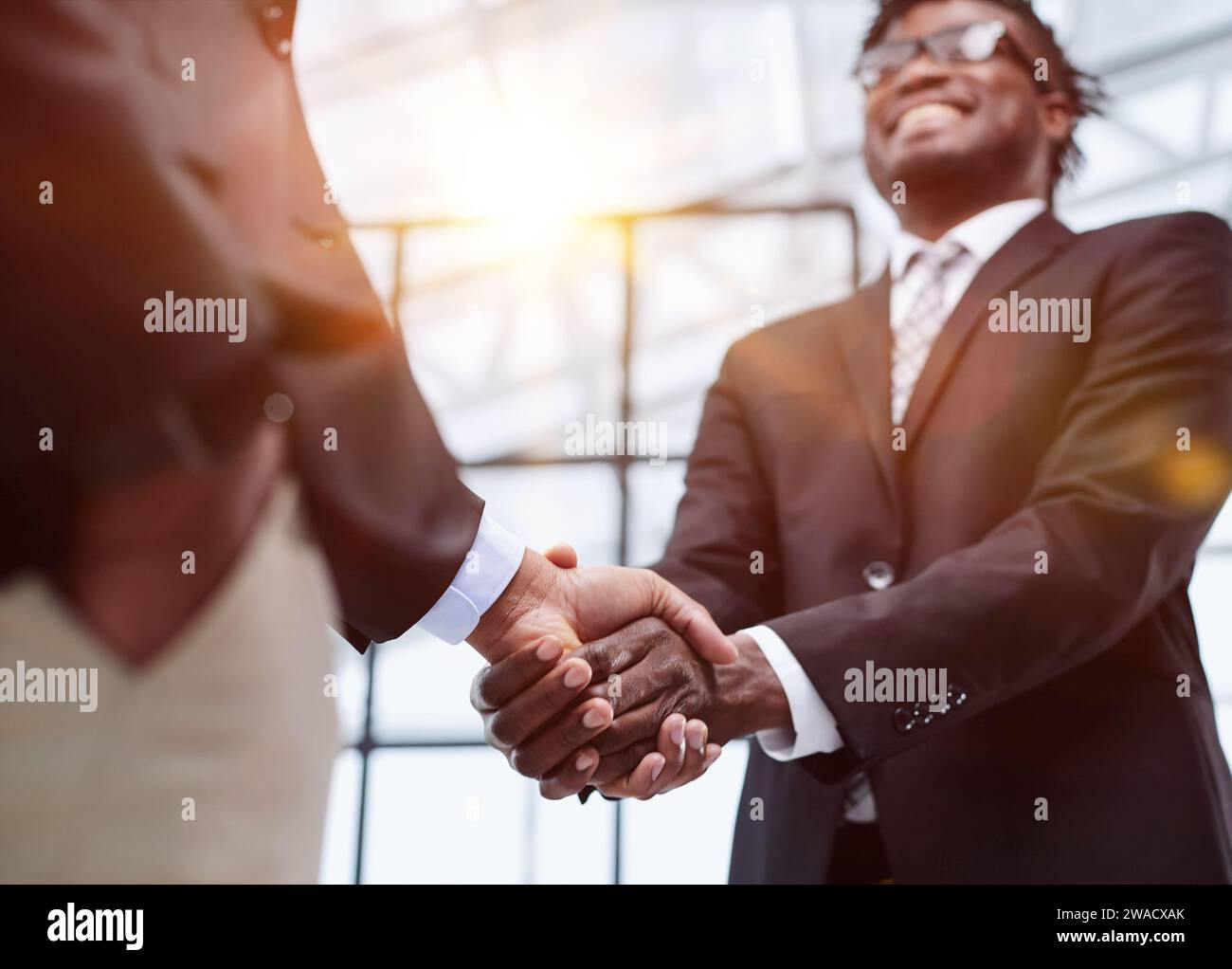 business people shake hands standing in the office Stock Photo - Alamy