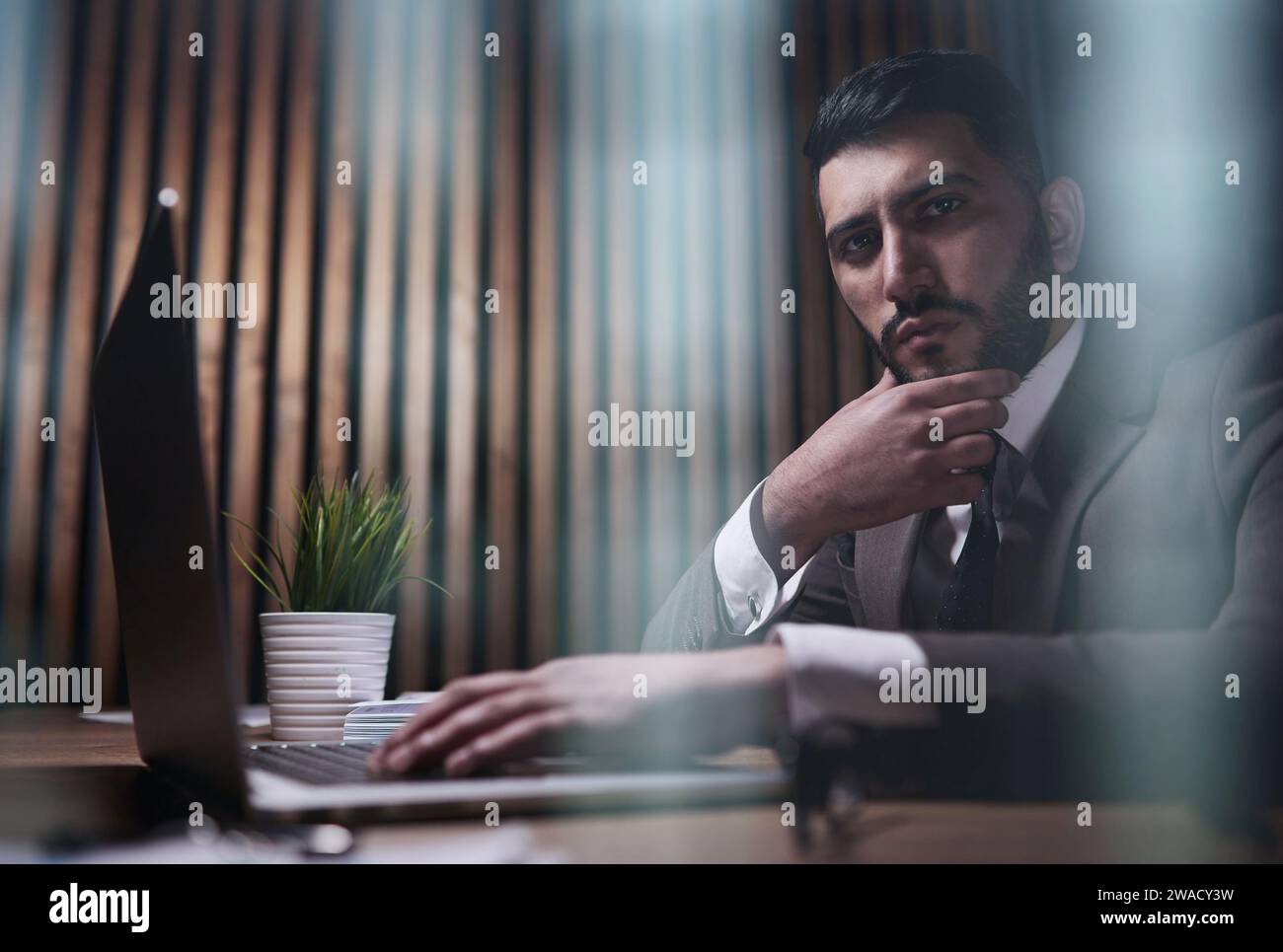 A man of Spanish appearance works at the office with a laptop Stock ...