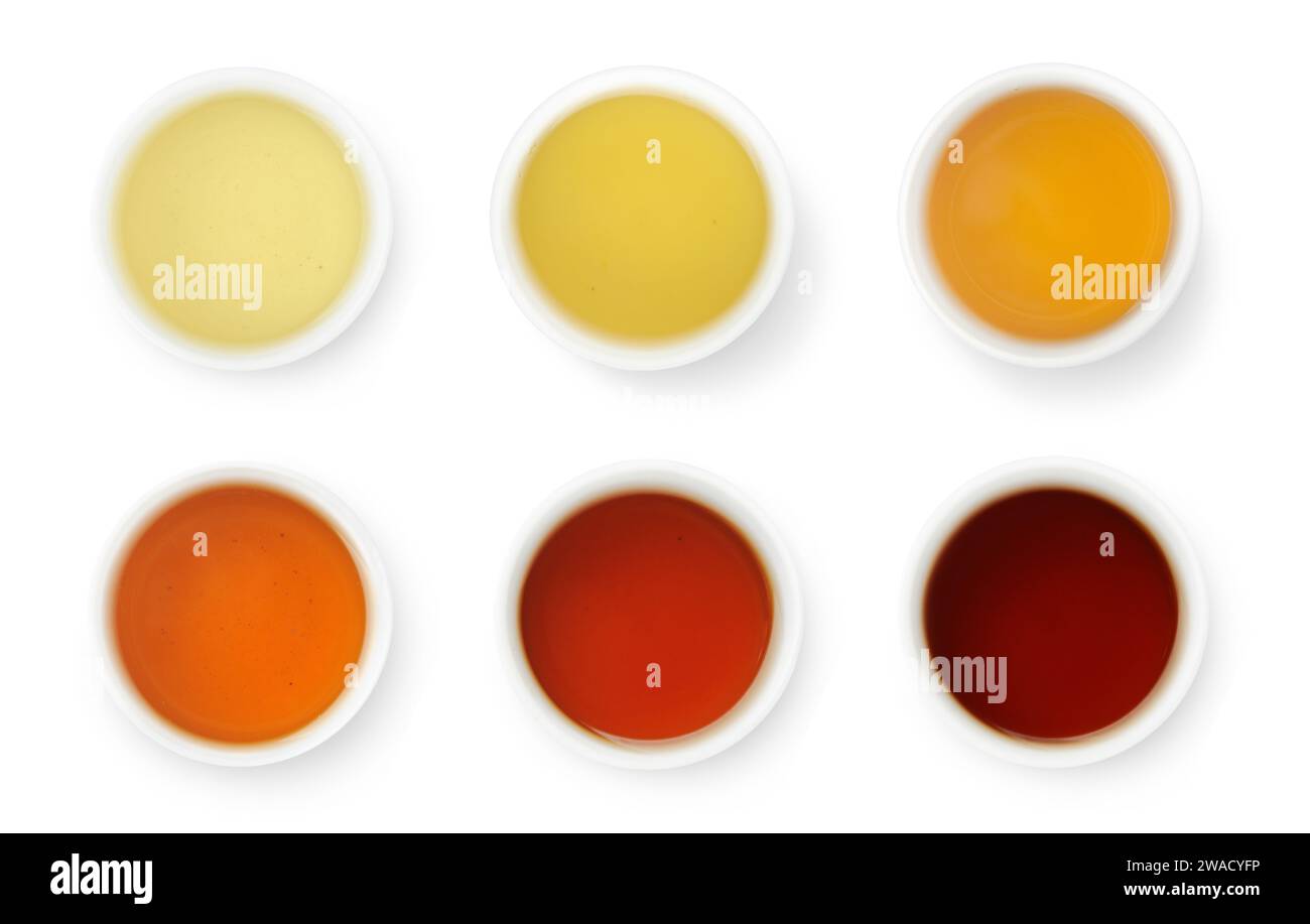 Brewed Chinese teas of different color in white bowls top view isolated ...