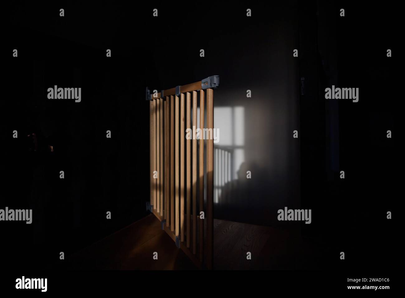 A morning scene featuring a safety baby gate open near a staircase ...