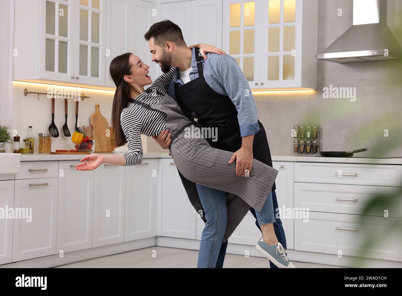 Happy lovely couple dancing together in kitchen Stock Photo - Alamy