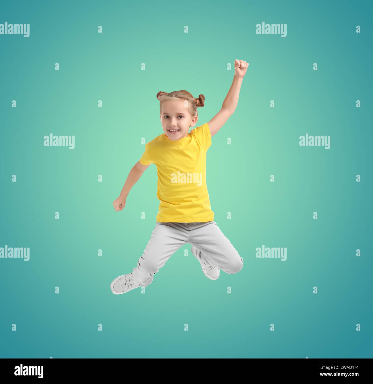 Happy cute girl jumping on color gradient background Stock Photo - Alamy