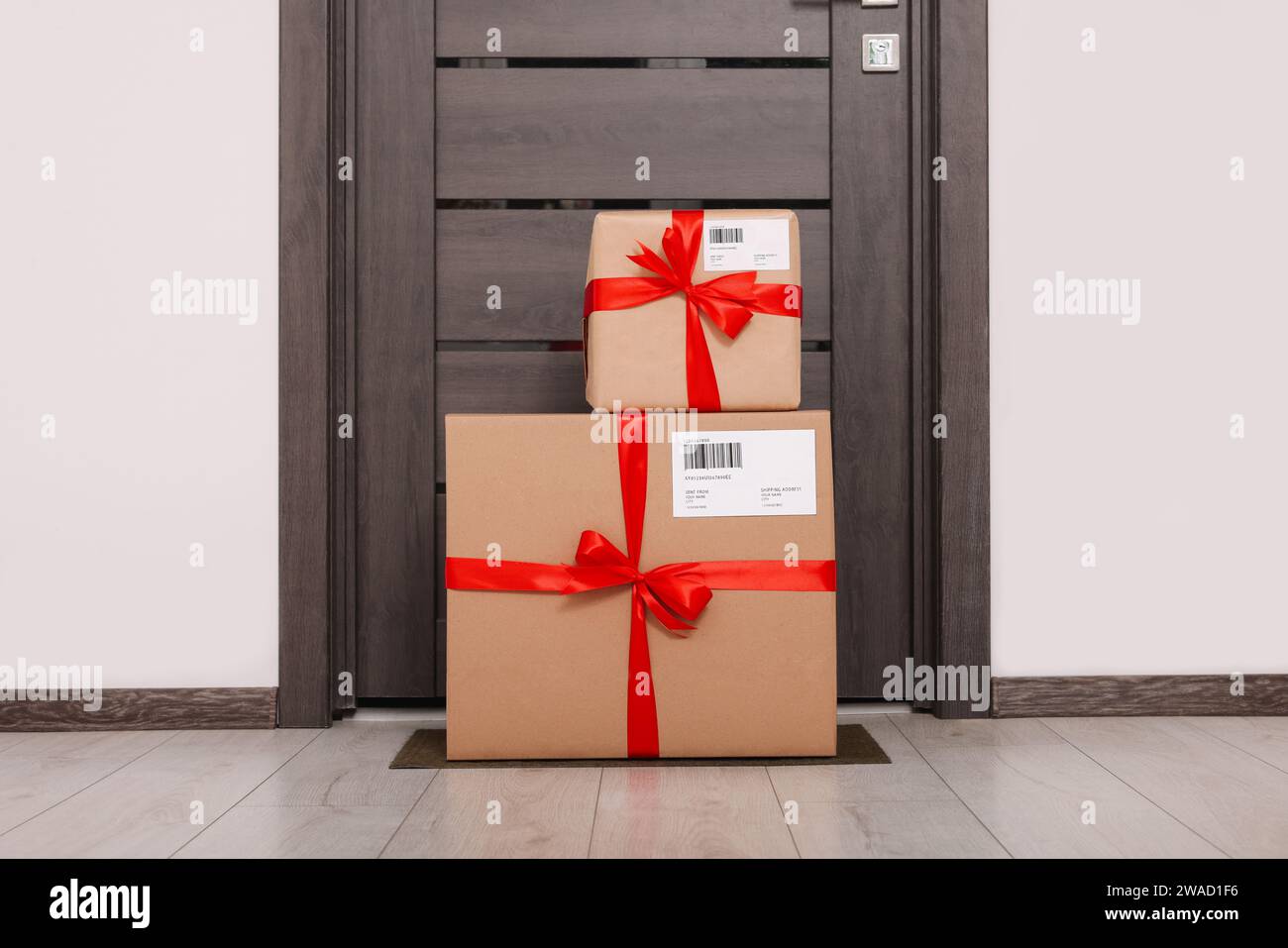 Christmas gift boxes on floor near door. Sending present by mail Stock ...