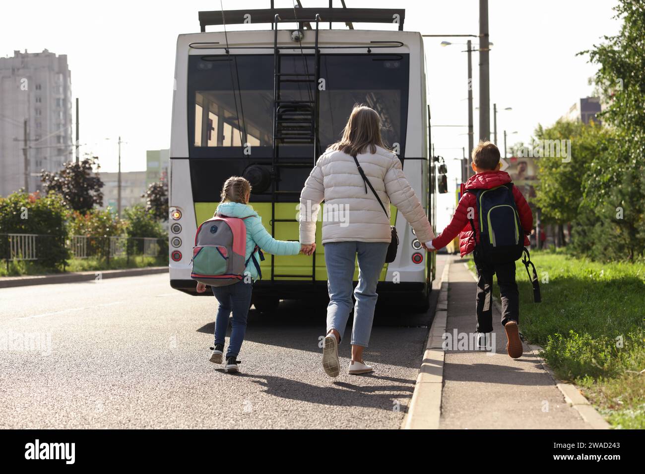 Being late for school. Senior woman and her grandchildren with ...