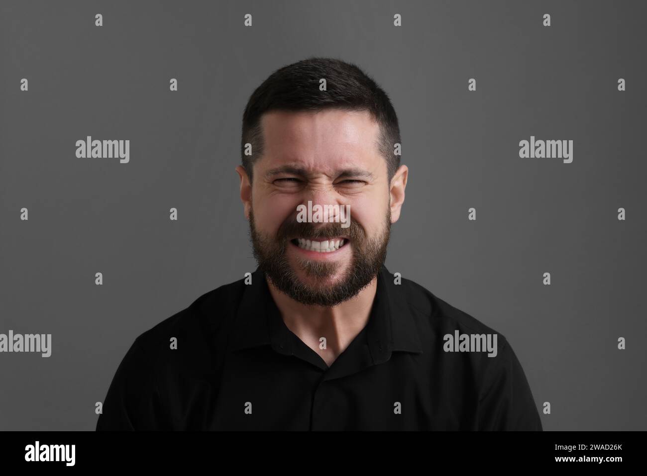 Personality concept. Angry man on grey background Stock Photo - Alamy