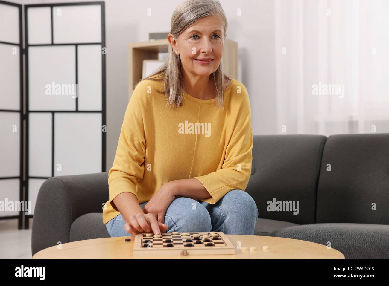Focused woman playing strategic board hi-res stock photography and ...