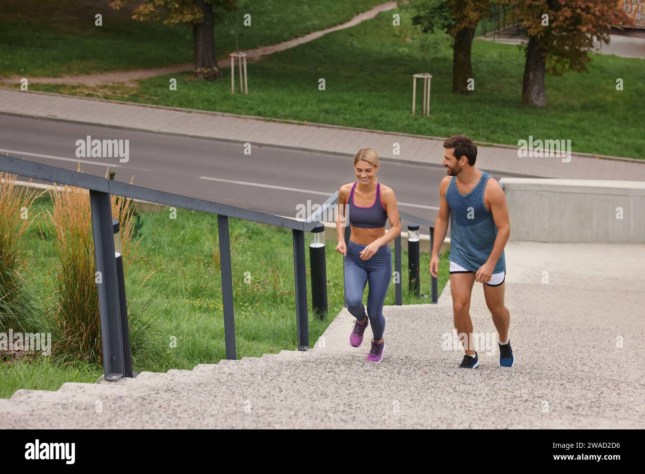 Two friends run up stairs hi-res stock photography and images - Alamy