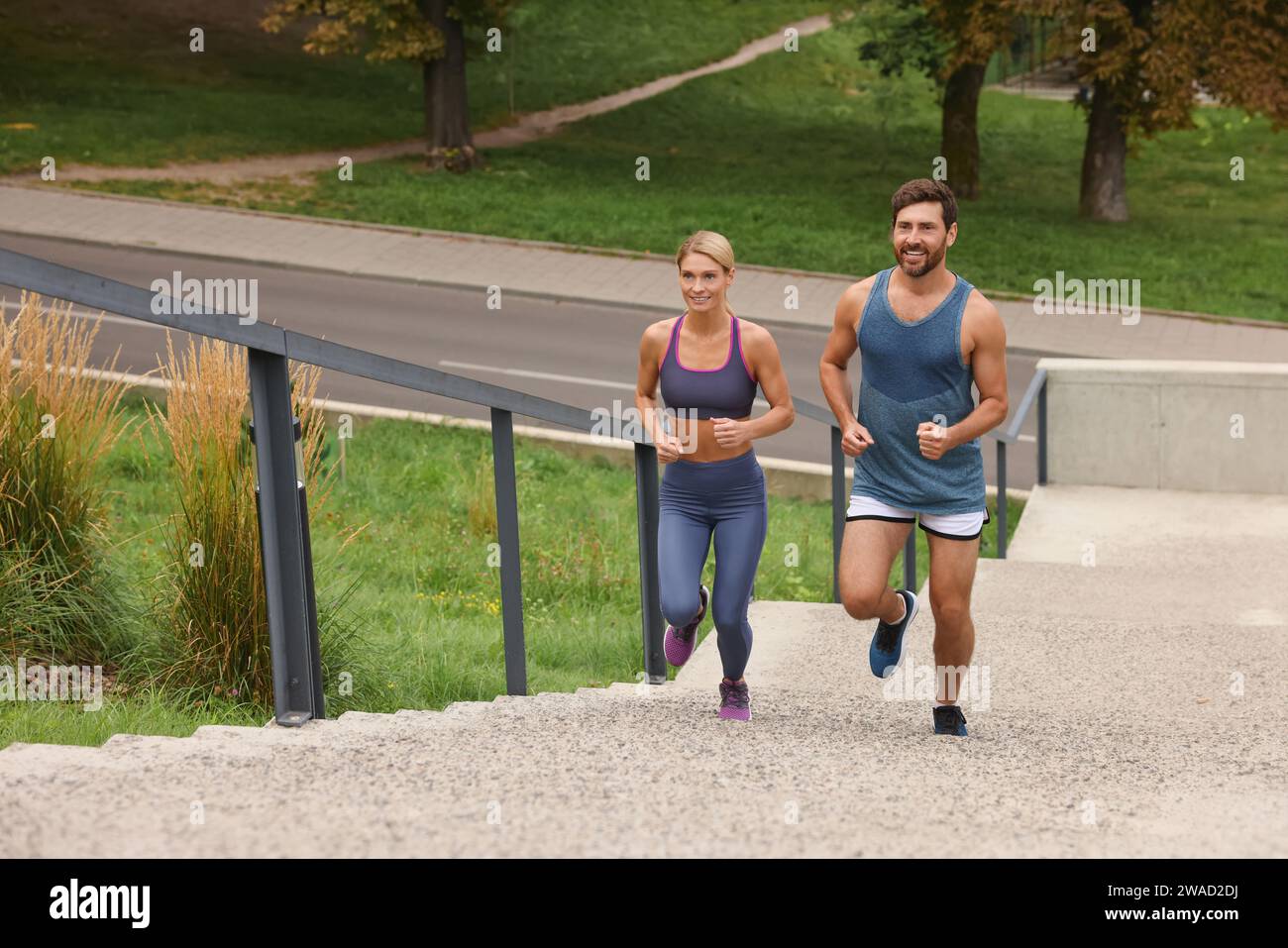 Two friends run up stairs hi-res stock photography and images - Alamy