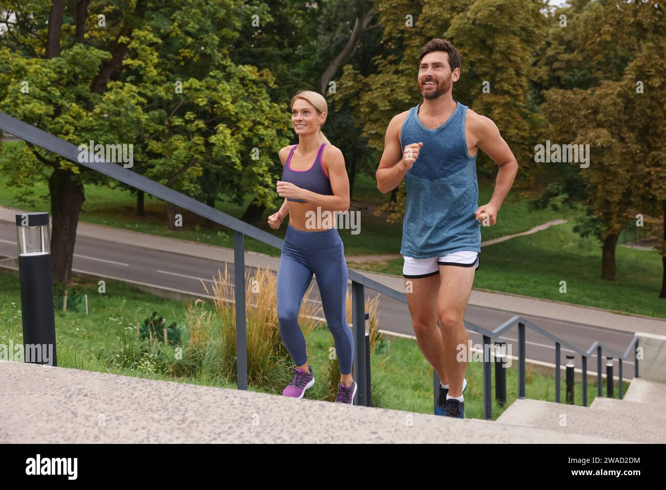 Two friends run up stairs hi-res stock photography and images - Alamy