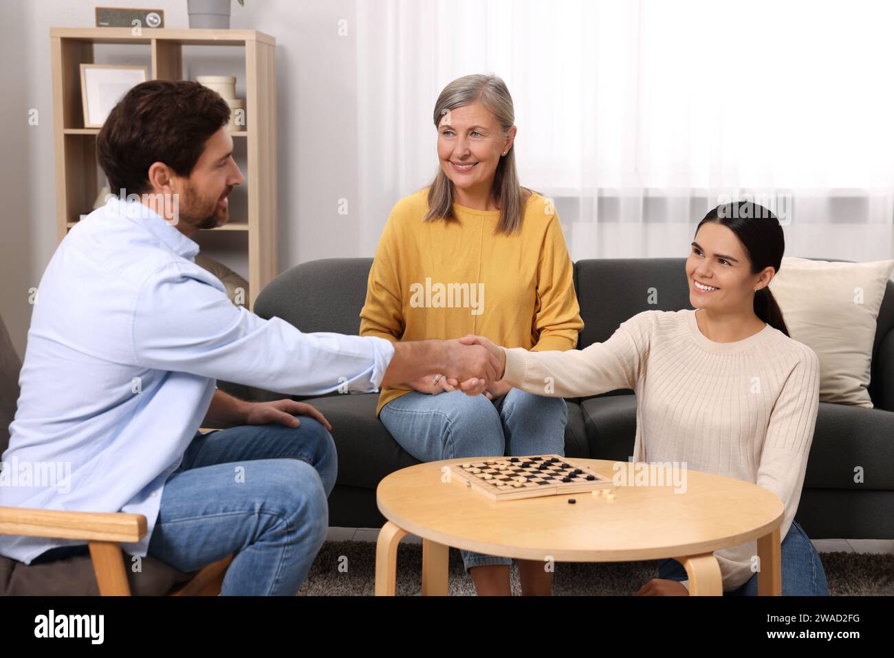 Checkers. Players shaking hands after game at home Stock Photo - Alamy