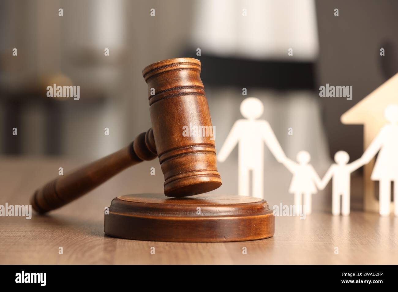 Law concept. Gavel and figures of parents with children on wooden table ...