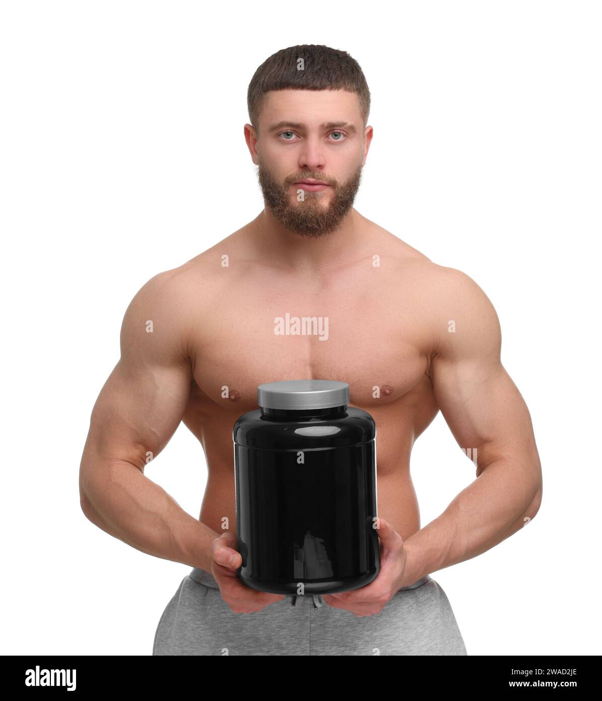 Young man with muscular body holding jar of protein powder on white ...
