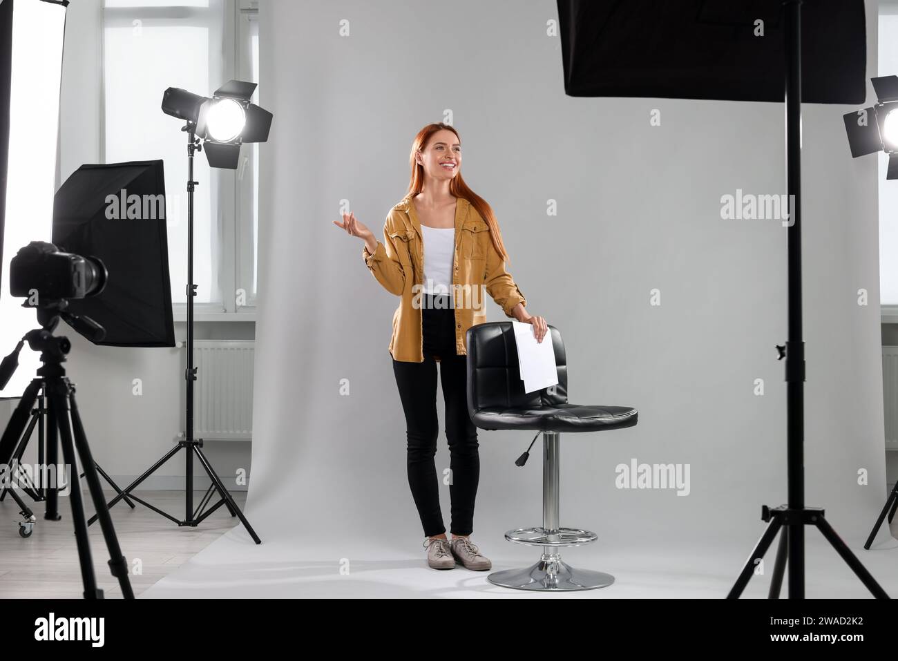 Casting call. Young woman with script performing on grey background in ...