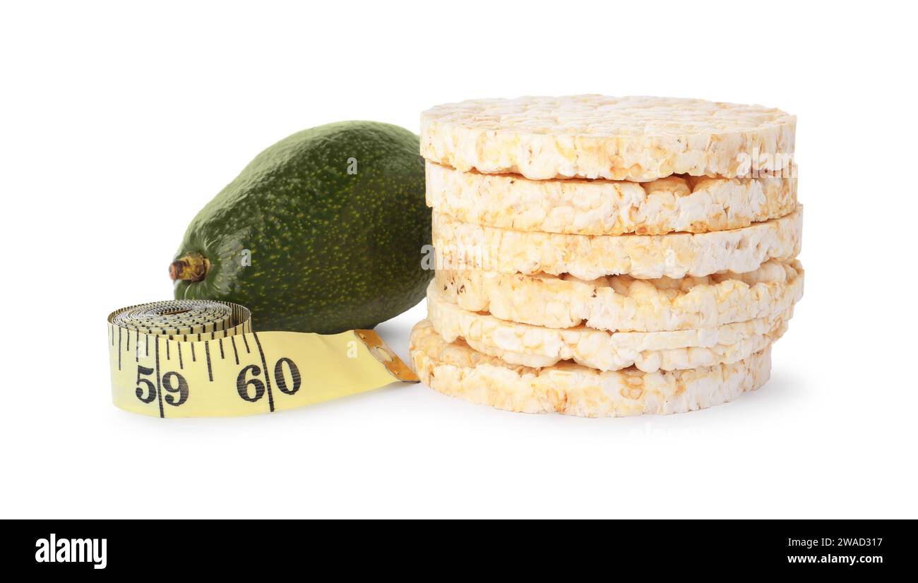 Healthy diet. Stack of puffed rice cakes, avocado and measuring tape ...