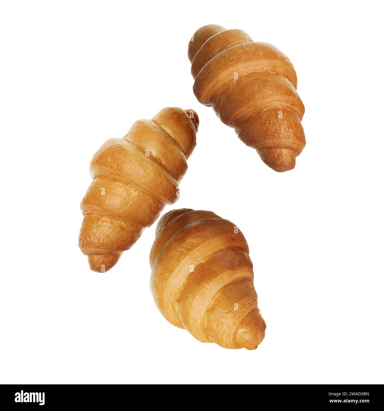 Crusty golden croissants falling on white background Stock Photo - Alamy