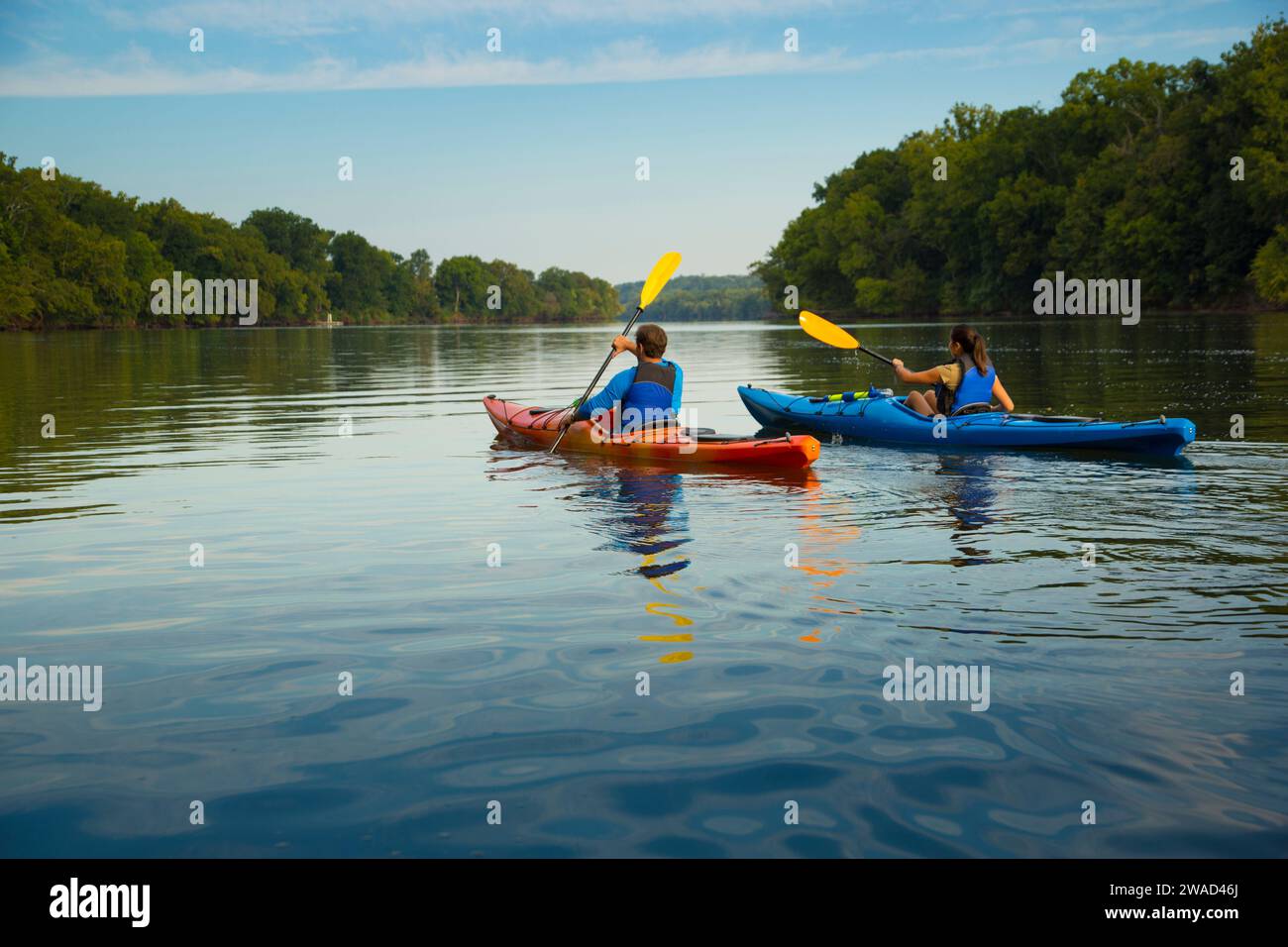 Couple kayaking in river Stock Photo - Alamy
