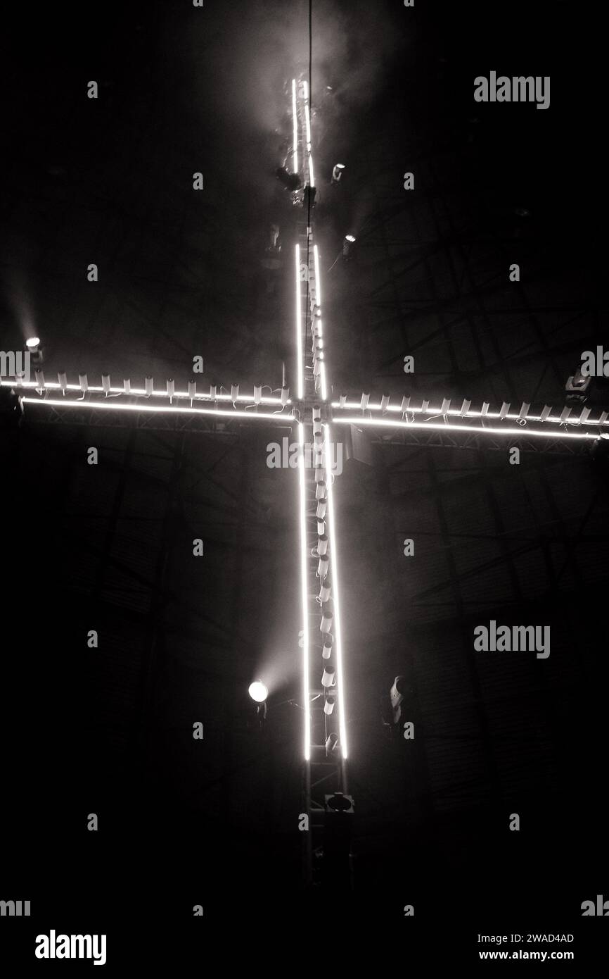 An illuminated cross, an overhead sound rig for a lunch party event in ...