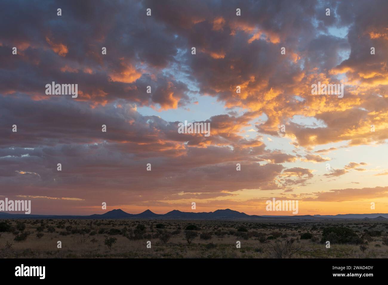 USA, New Mexico, Santa Fe, Dramatic sunset sky above Cerrillos Hills ...