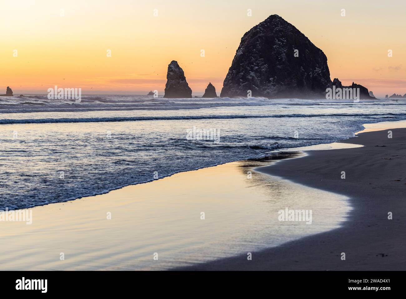 USA, Oregon, Silhouette of Haystack Rock at Cannon Beach at sunset ...
