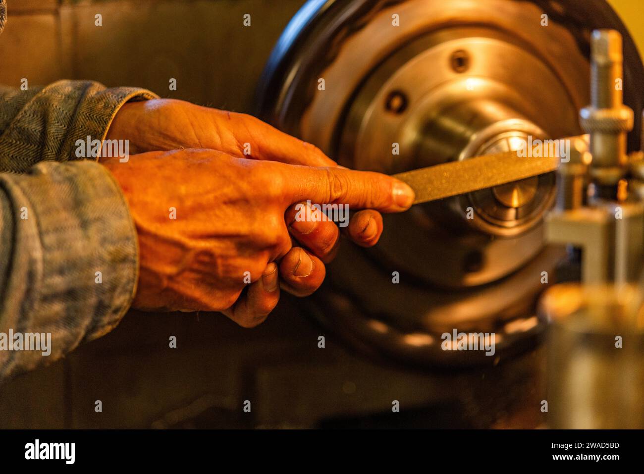 Hands of senior wood and metal craftsman using tools in workshop Stock ...