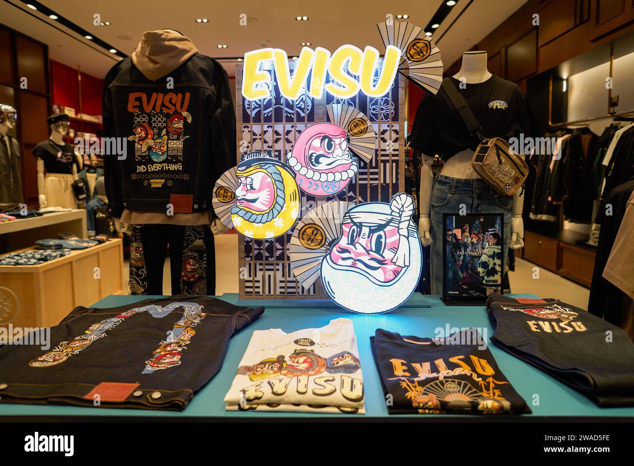 SINGAPORE - NOVEMBER 05, 2023: various clothes displayed inside Evisu ...