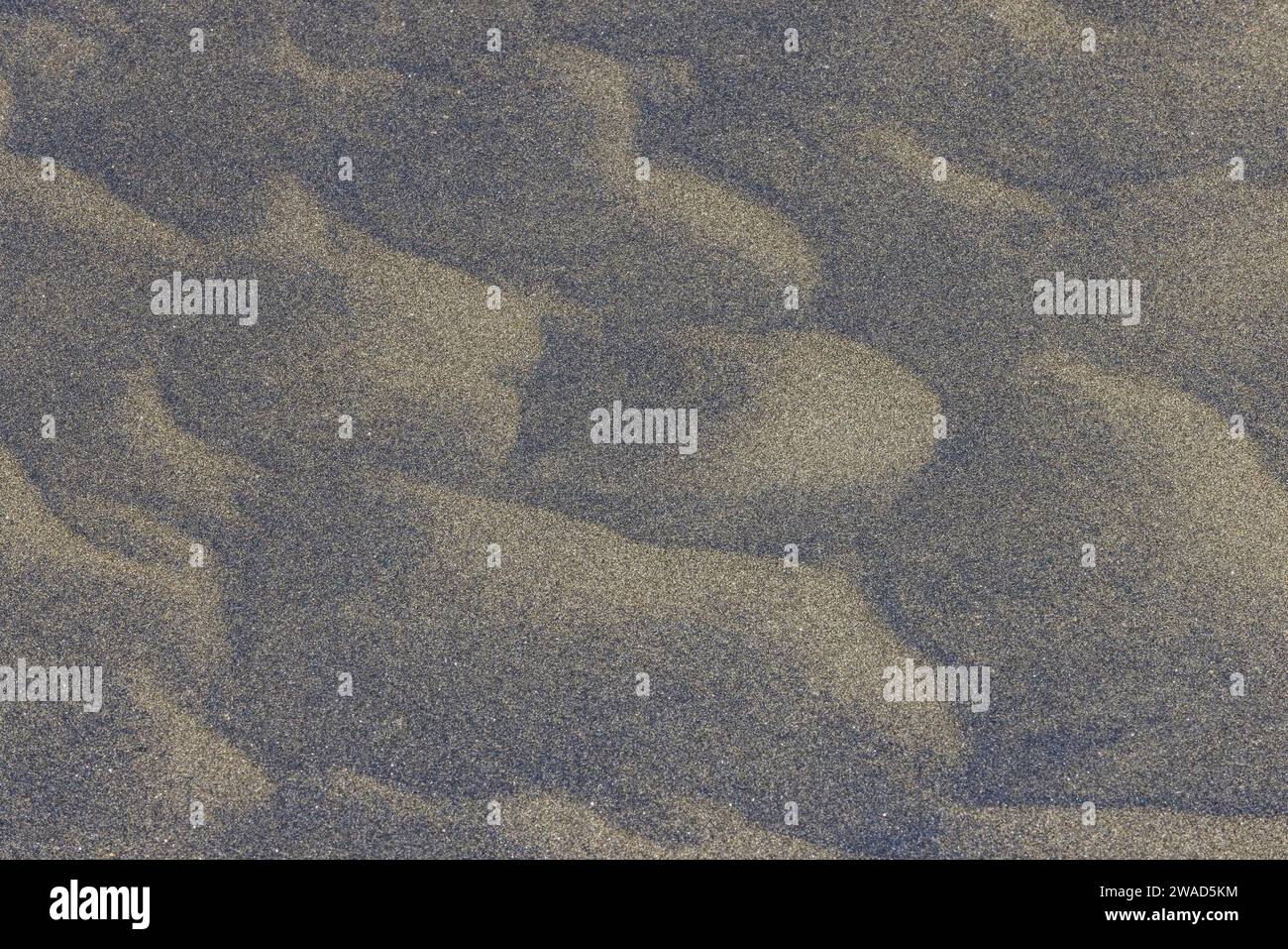 Wind sculpted patterns in beach sand Stock Photo - Alamy