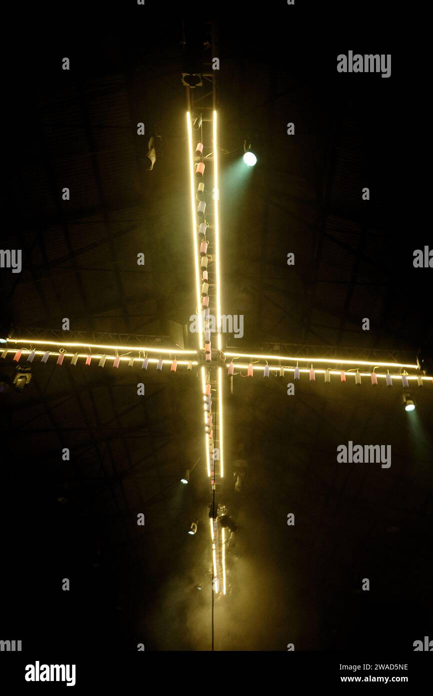 Dramatic lighting on a large cross, sound & lighting rigging suspended ...