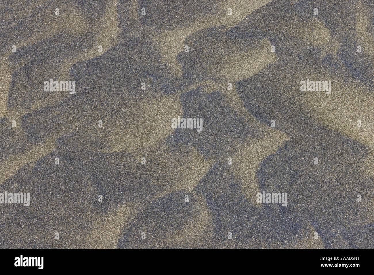 Wind sculpted patterns in beach sand Stock Photo - Alamy