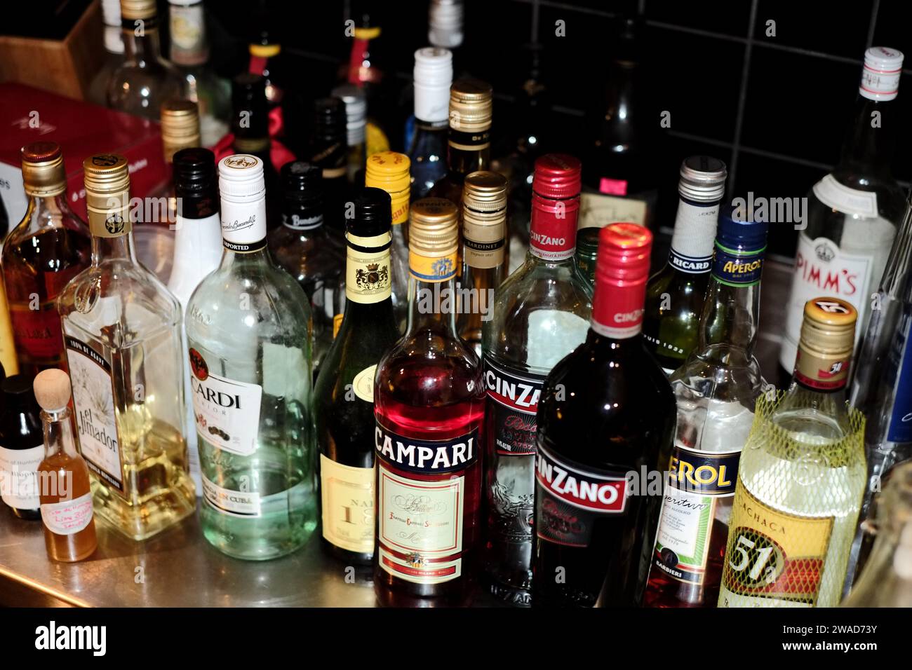 Bottles of booze, spirts, rum and whisky, alcohol displayed on kitchen ...