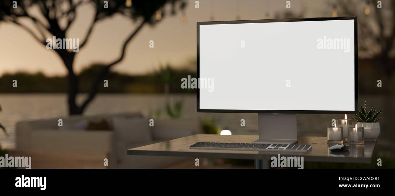 A white-screen computer mockup on a desk with a blurred background of a beautiful lounge terrace ...