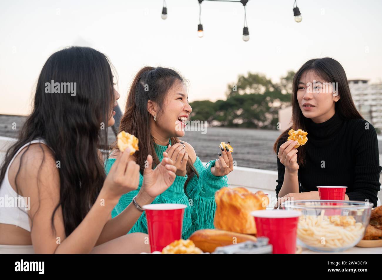 Group of cheerful young Asian female friends are laughing, enjoying ...