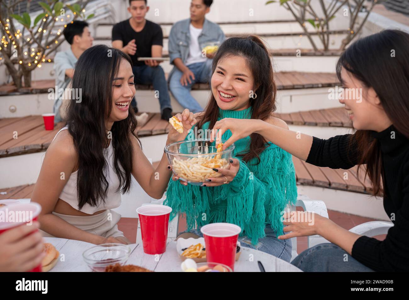 Group of happy Asian female friends are enjoying partying together on a ...