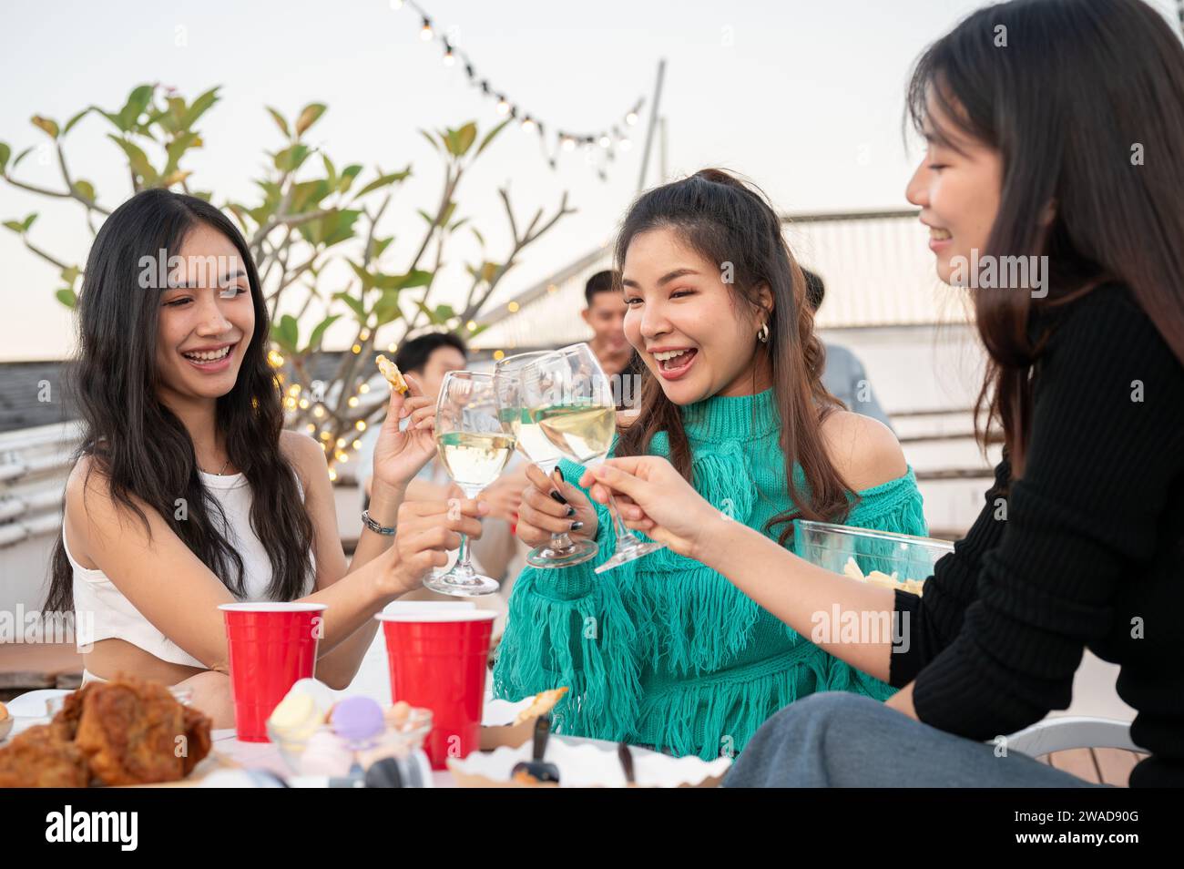 Group of attractive young Asian female friends are toasting champagne ...