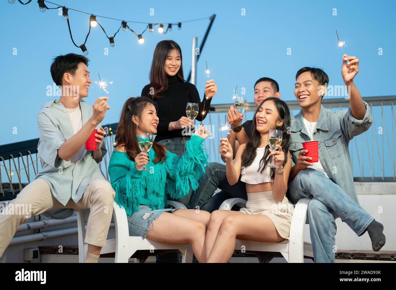 Group of happy and attractive young Asian friends are enjoying partying ...