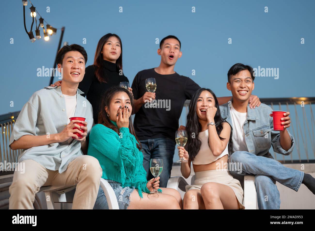 Group of attractive, cheerful Asian friends are enjoying partying on a ...