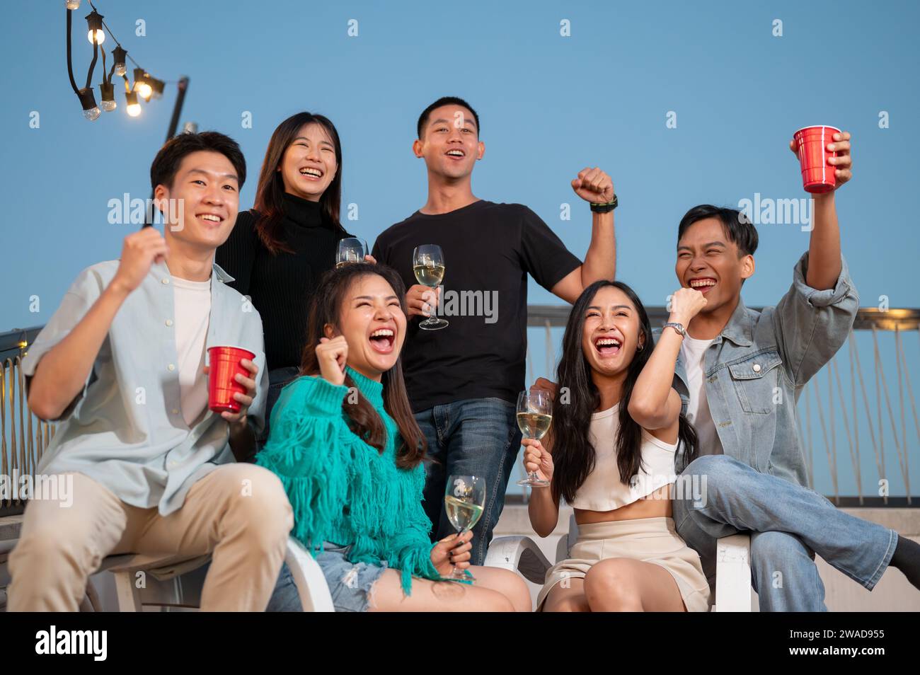Group of attractive, cheerful Asian friends are enjoying partying on a ...