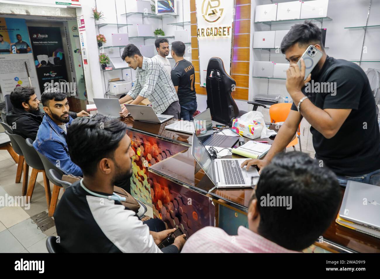 Customers buying computers and other digital accessories at a computer market in Dhaka ...