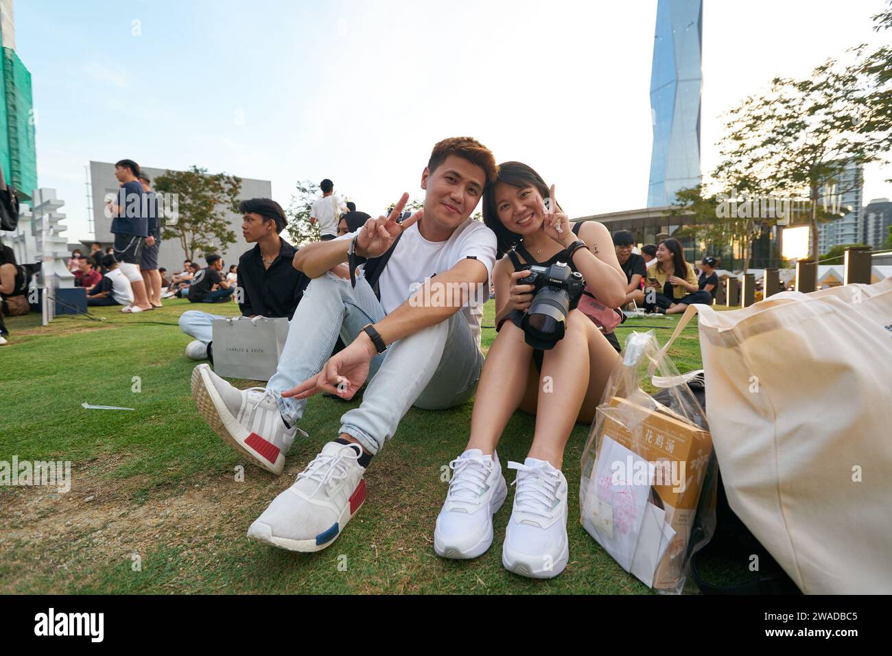 KUALA LUMPUR, MALAYSIA - CIRCA MAY, 2023: people sit and posing in the ...