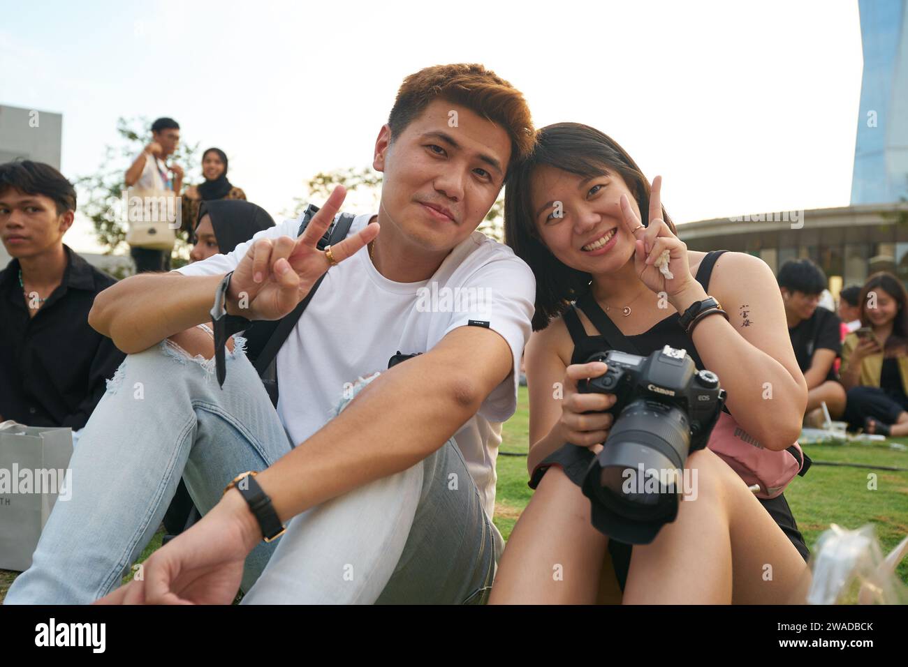 KUALA LUMPUR, MALAYSIA - CIRCA MAY, 2023: people sit and posing in the ...